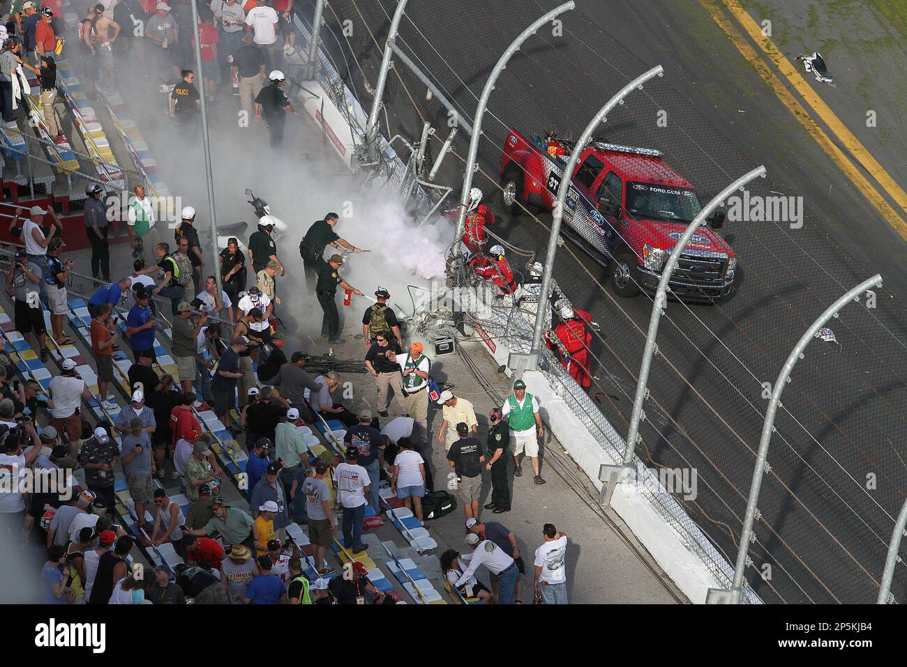 The engine of driver Kyle Larson burns in the spectator grandstand area ...