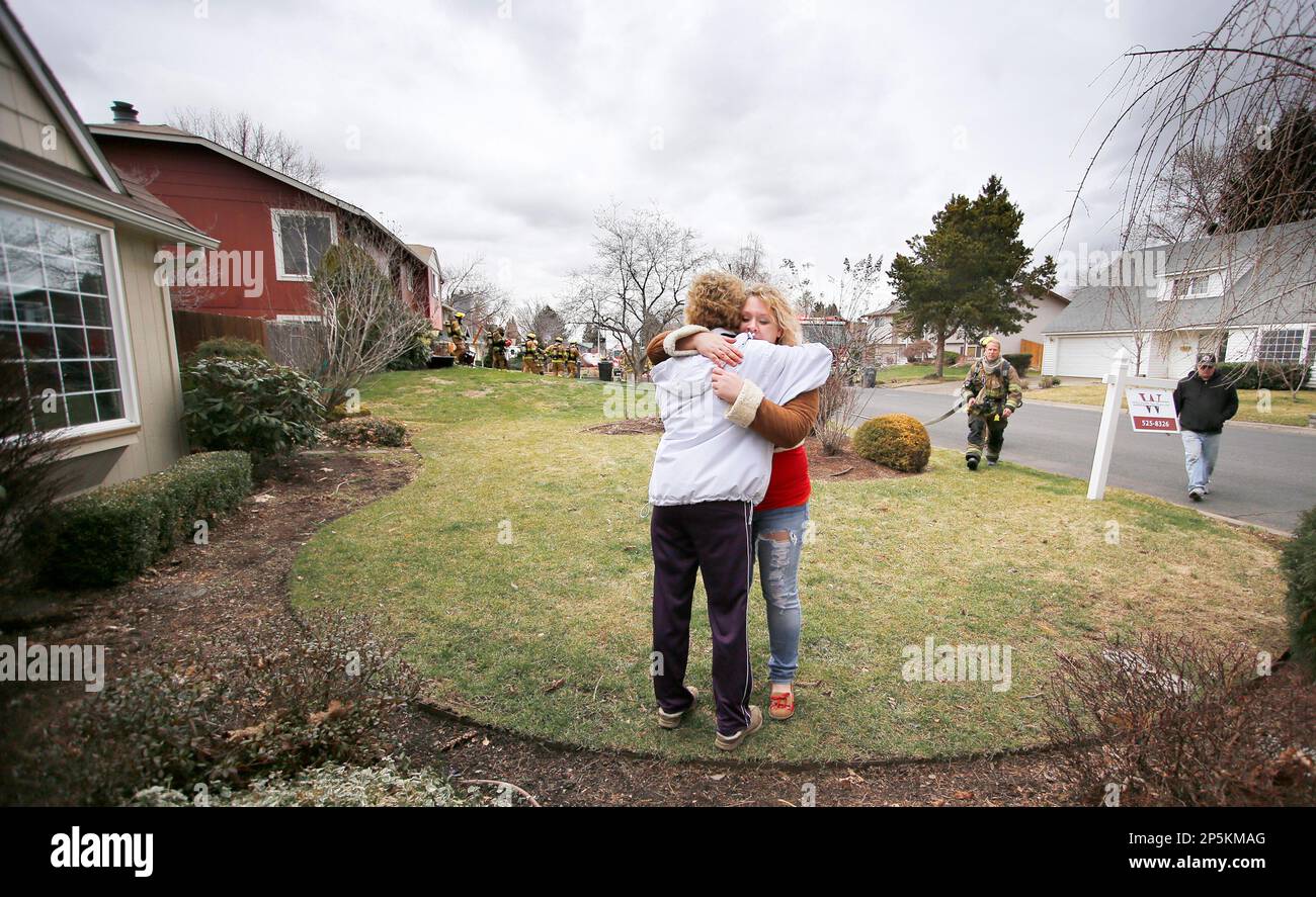 Nicole Reavis (in red), daughter of the home owner in Walla Walla, Wash ...