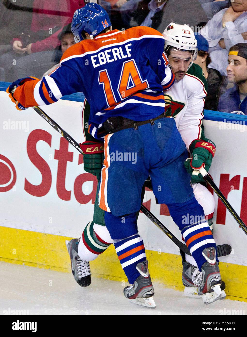 Minnesota Wild's Cal Clutterbuck (22) is checked by Edmonton Oilers ...