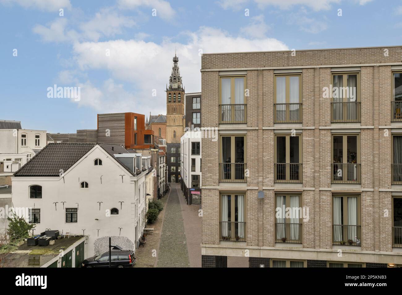 an urban area with buildings and cars parked on the street in front of ...