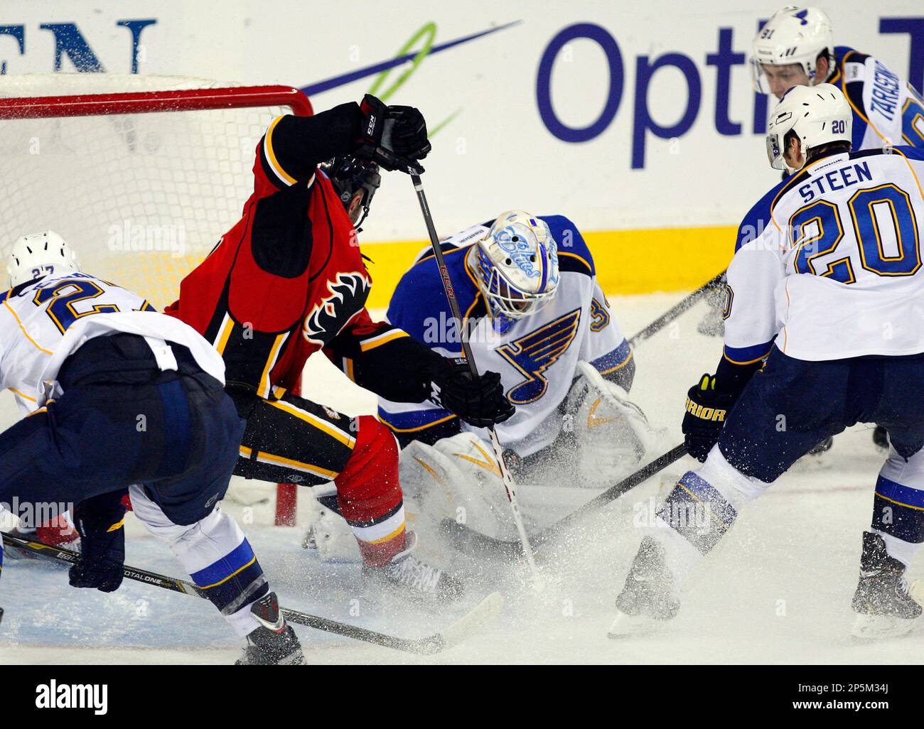 St. Louis Blues goalie Jake Allen, center, is pressured by Calgary ...