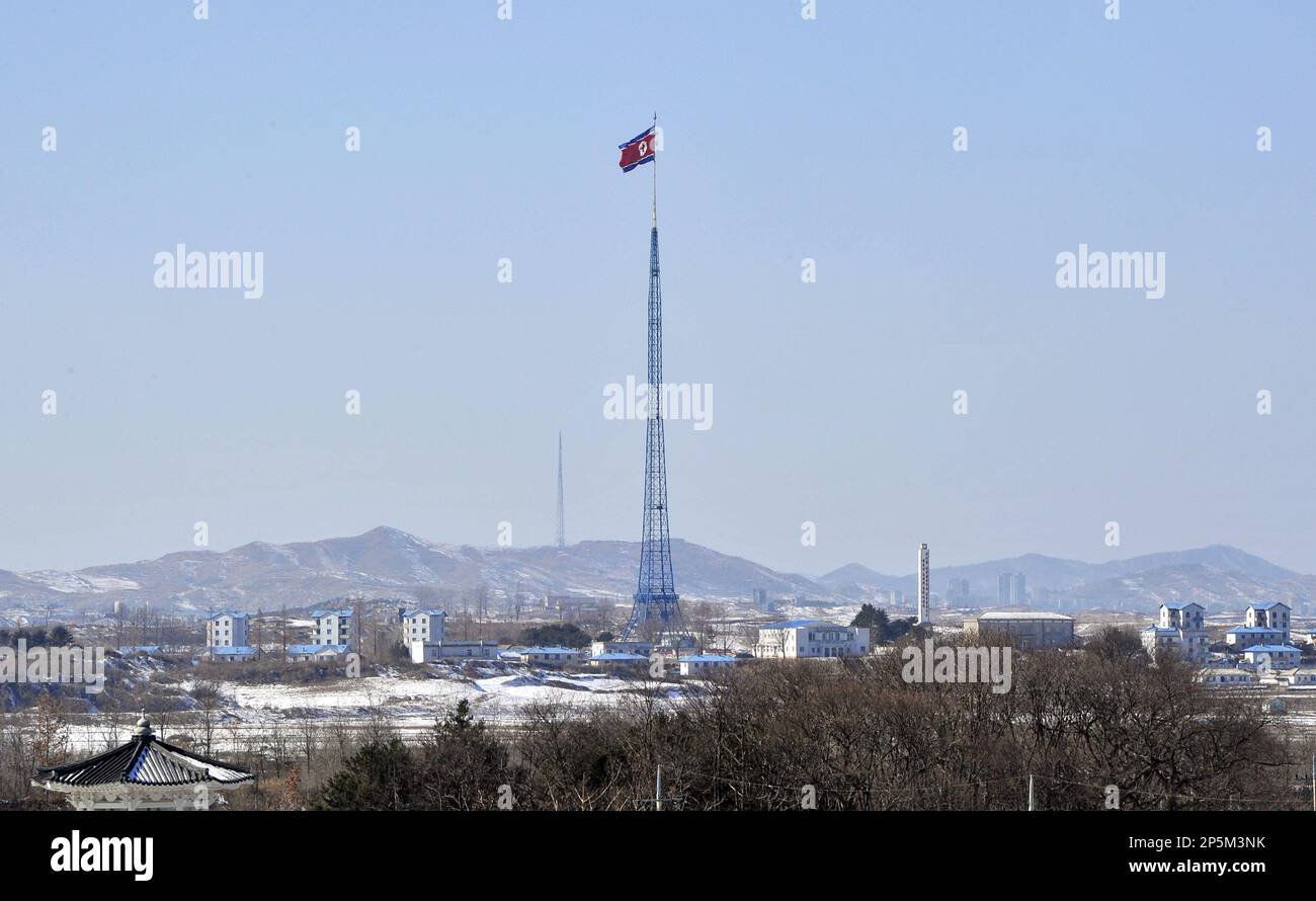 A giant North Korean flag flutters on the top of a tower in the ...