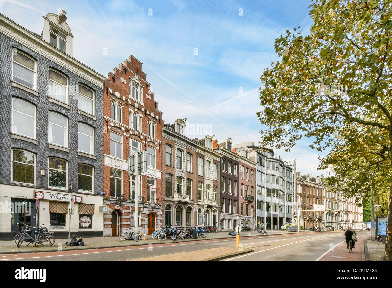 a city street with buildings and bicycles parked on the side of the ...