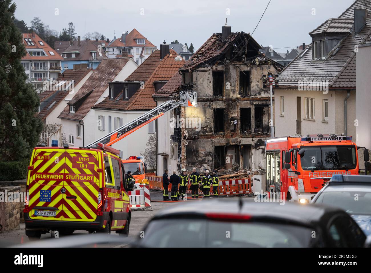 Stuttgart, Germany. 07th Mar, 2023. Firefighters stand by a destroyed ...