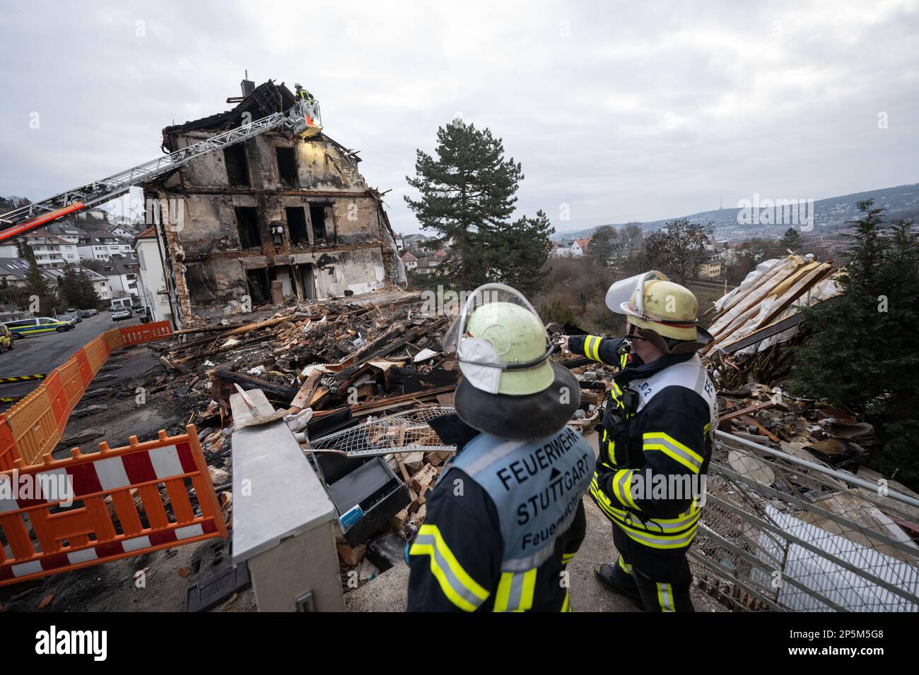 Stuttgart, Germany. 07th Mar, 2023. Firefighters stand by a destroyed ...