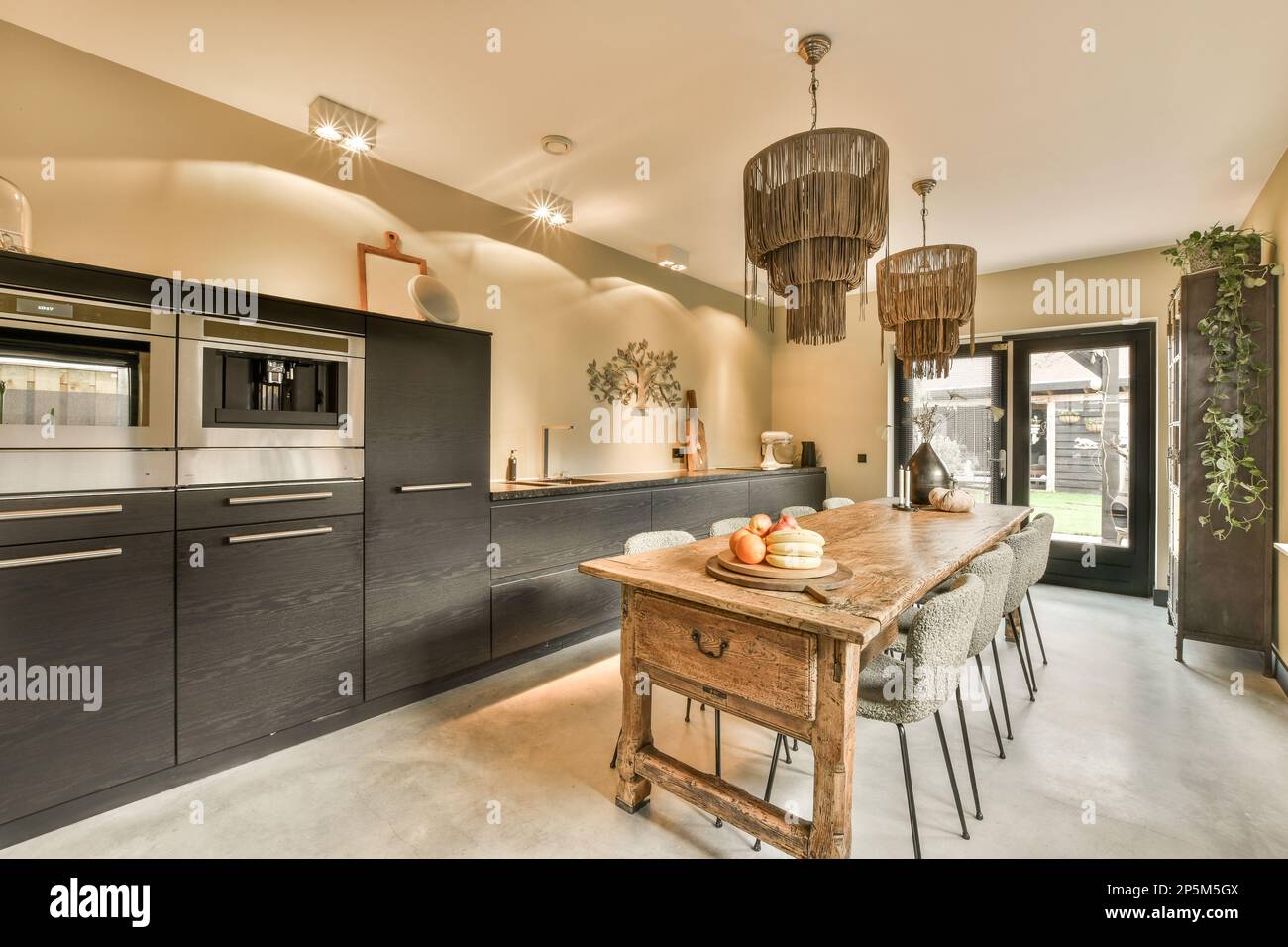 a modern kitchen with an island table and chairs in the middle of the ...