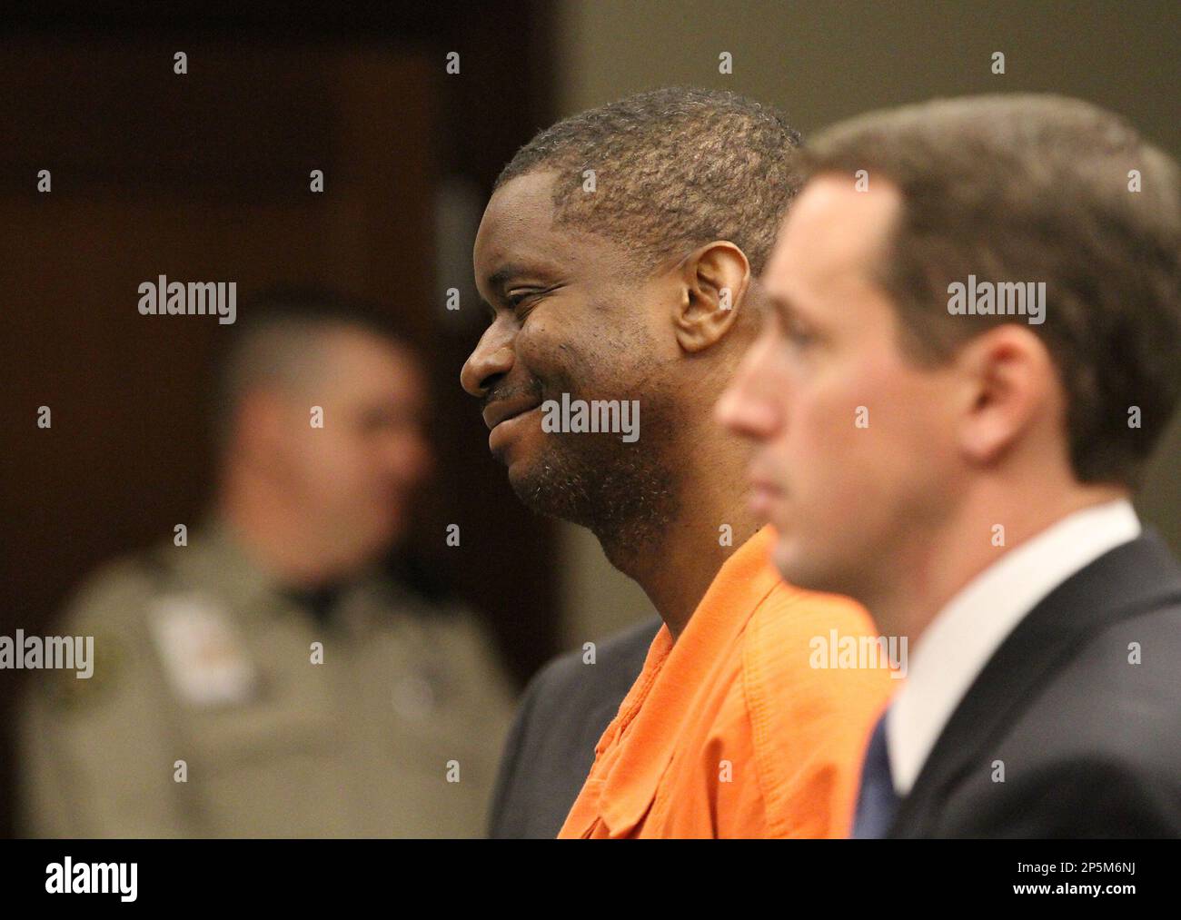 John McNeil, left, smiles as he hears he will be able to travel to ...
