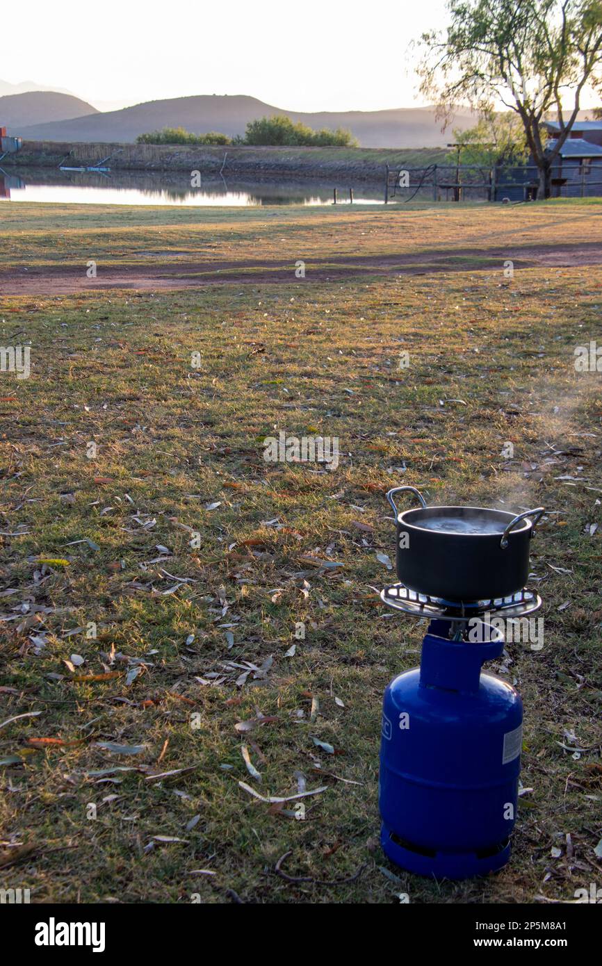 Cooking outdoors on a gas ring stove while out camping Stock Photo - Alamy