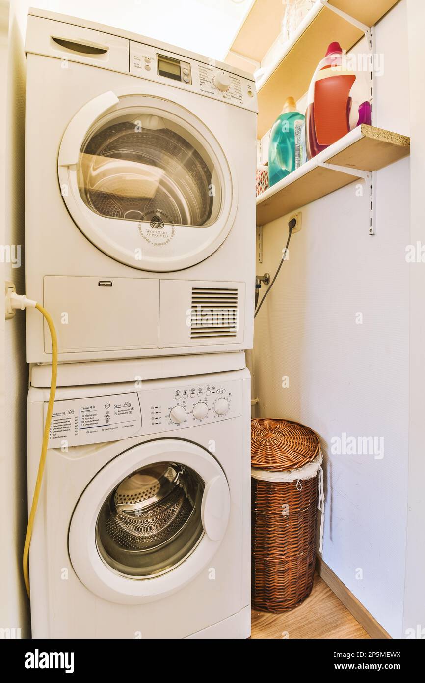 a white washer and dryer in a laundry room with wood flooring on the ...