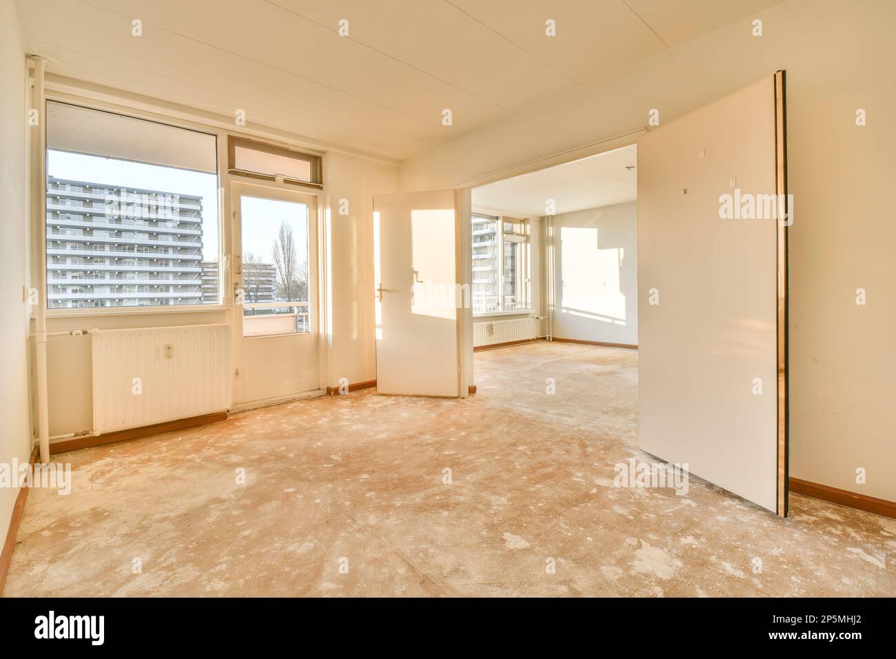 an empty room with no one person in it and the view out to the city ...