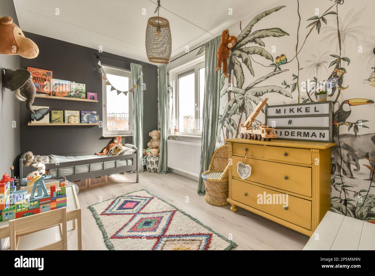 a kid's room with an animal themed wallpaper on the walls and wooden ...