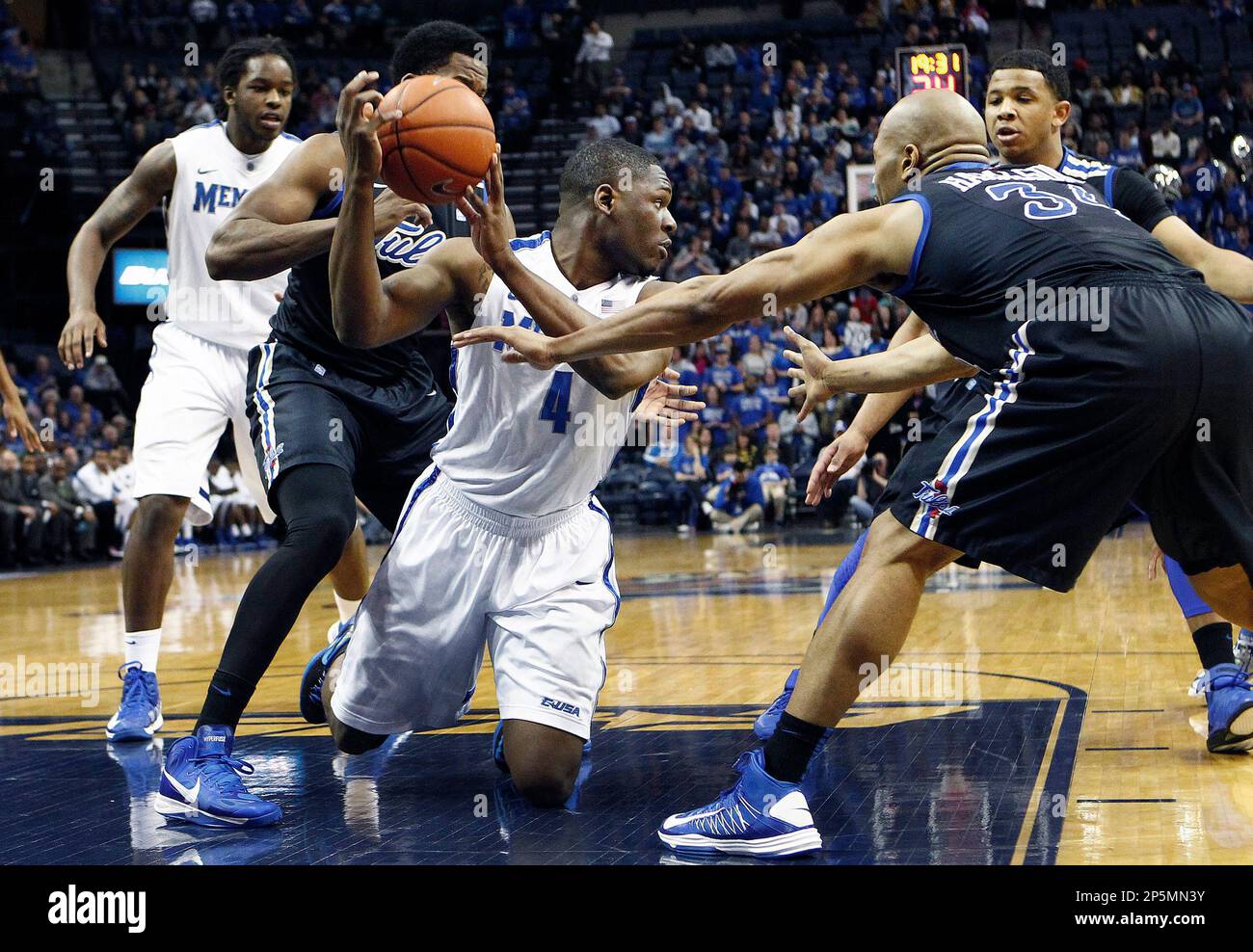 Memphis' Adonis Thomas (4) looks to make a pass after falling to the ...