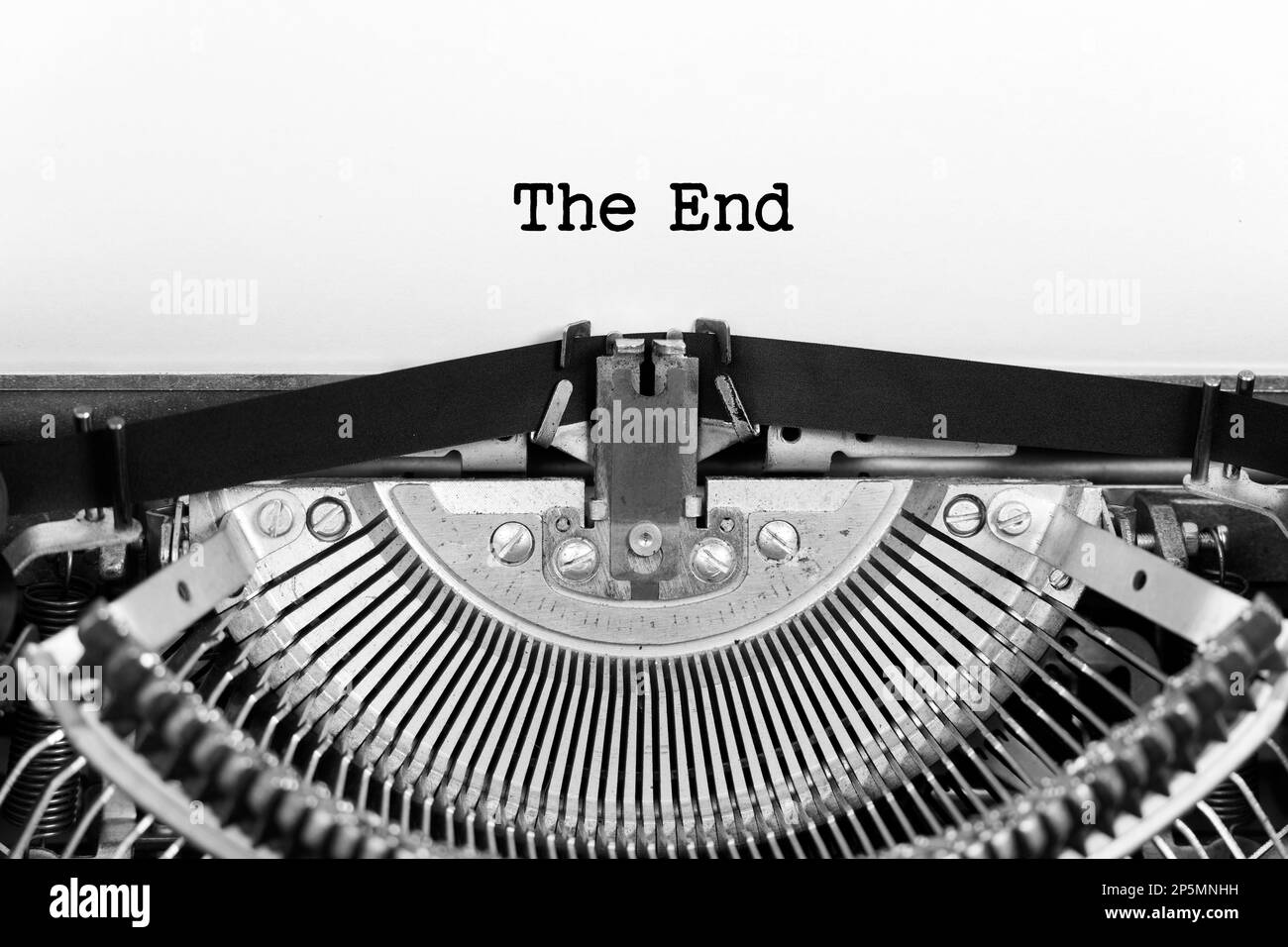 The End phrase closeup being typing and centered on a sheet of paper on ...