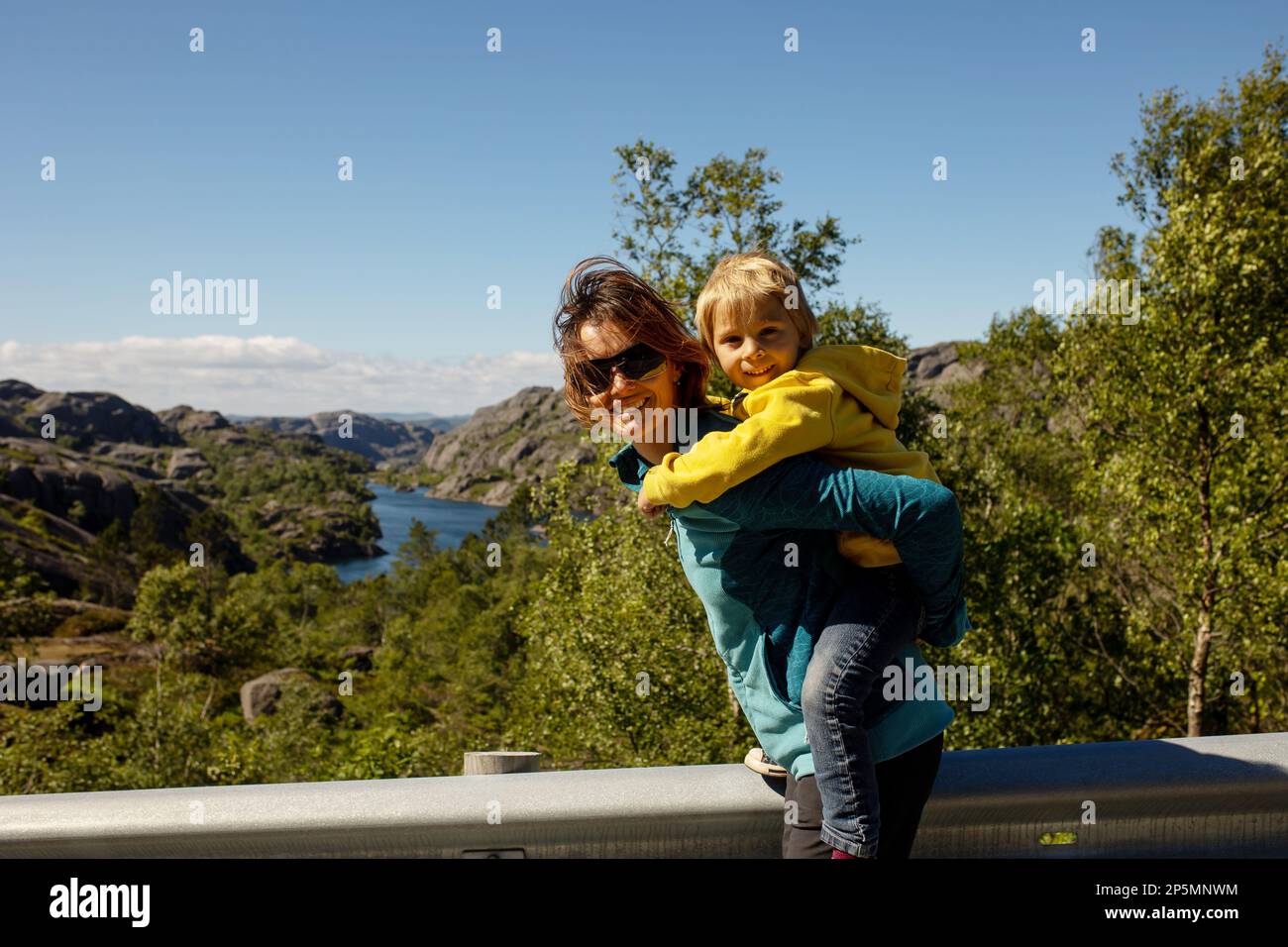 Happy people, enjoying amazing views in South Norway coastline, fjords ...