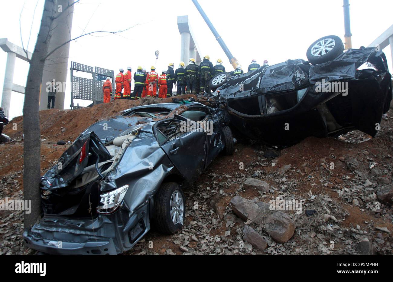 Rescuers work at the accident site where an expressway bridge partially ...