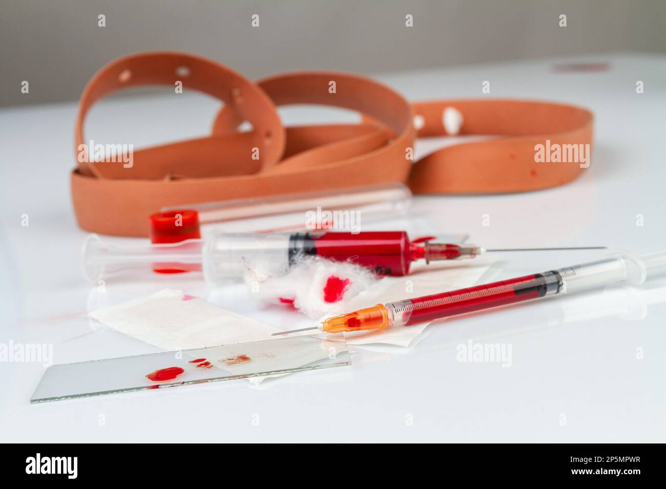 Close up syringes filled with red blood. Glass sheet test Stock Photo ...