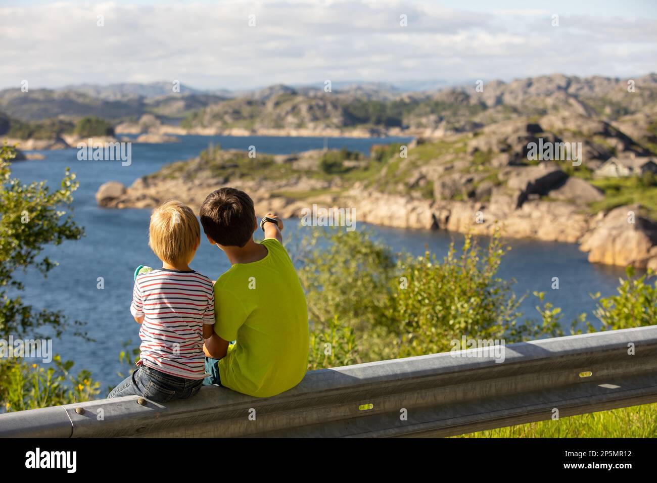 Happy people, enjoying amazing views in South Norway coastline, fjords ...