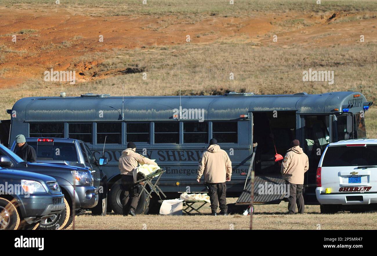 Law enforcement personnel load provisions into a bus during the third ...