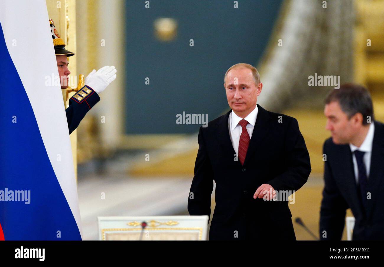 Russian President Vladimir Putin, center, enters a hall to attend a ...