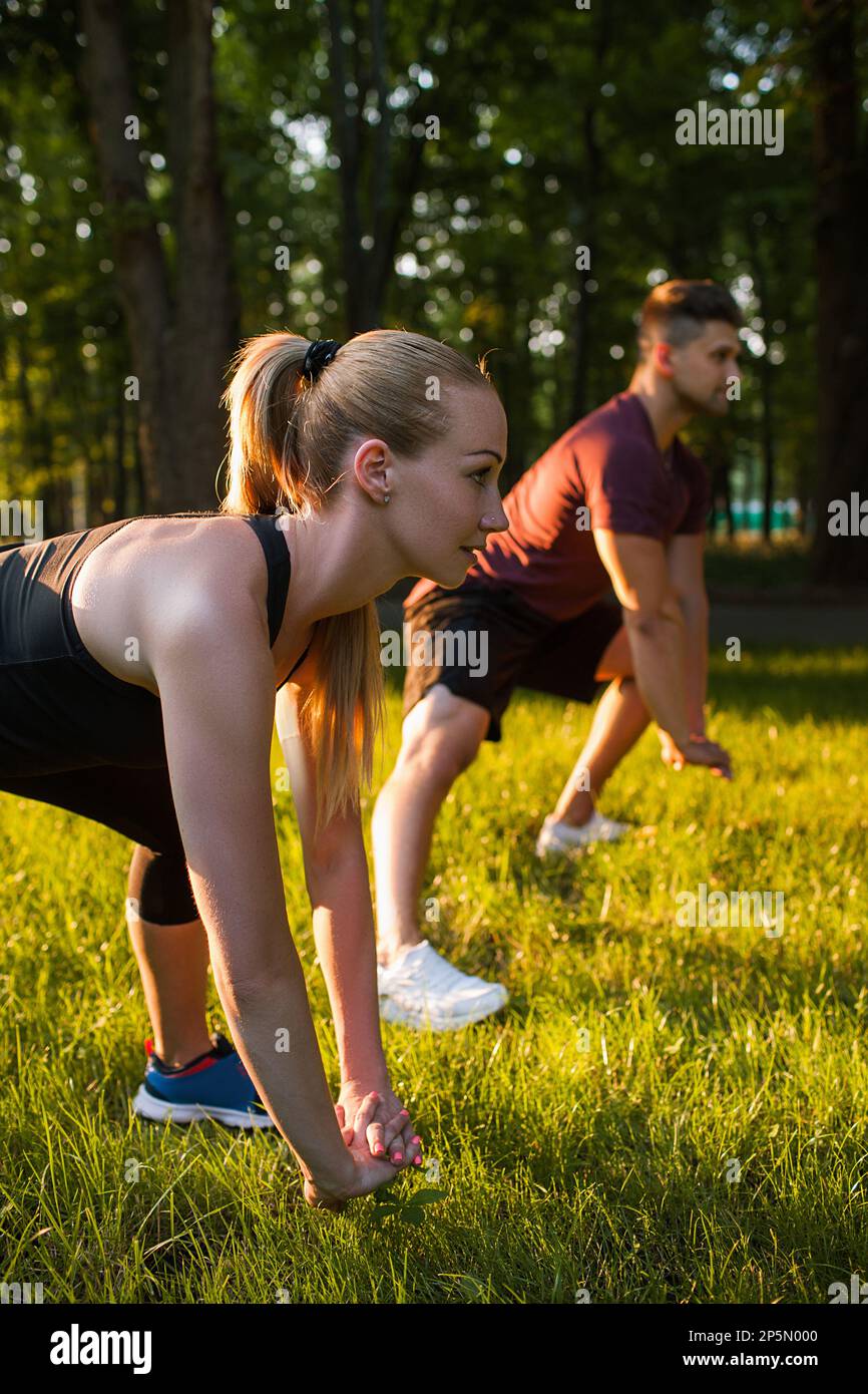 paired workout outdoor fitness sport exercises Stock Photo - Alamy