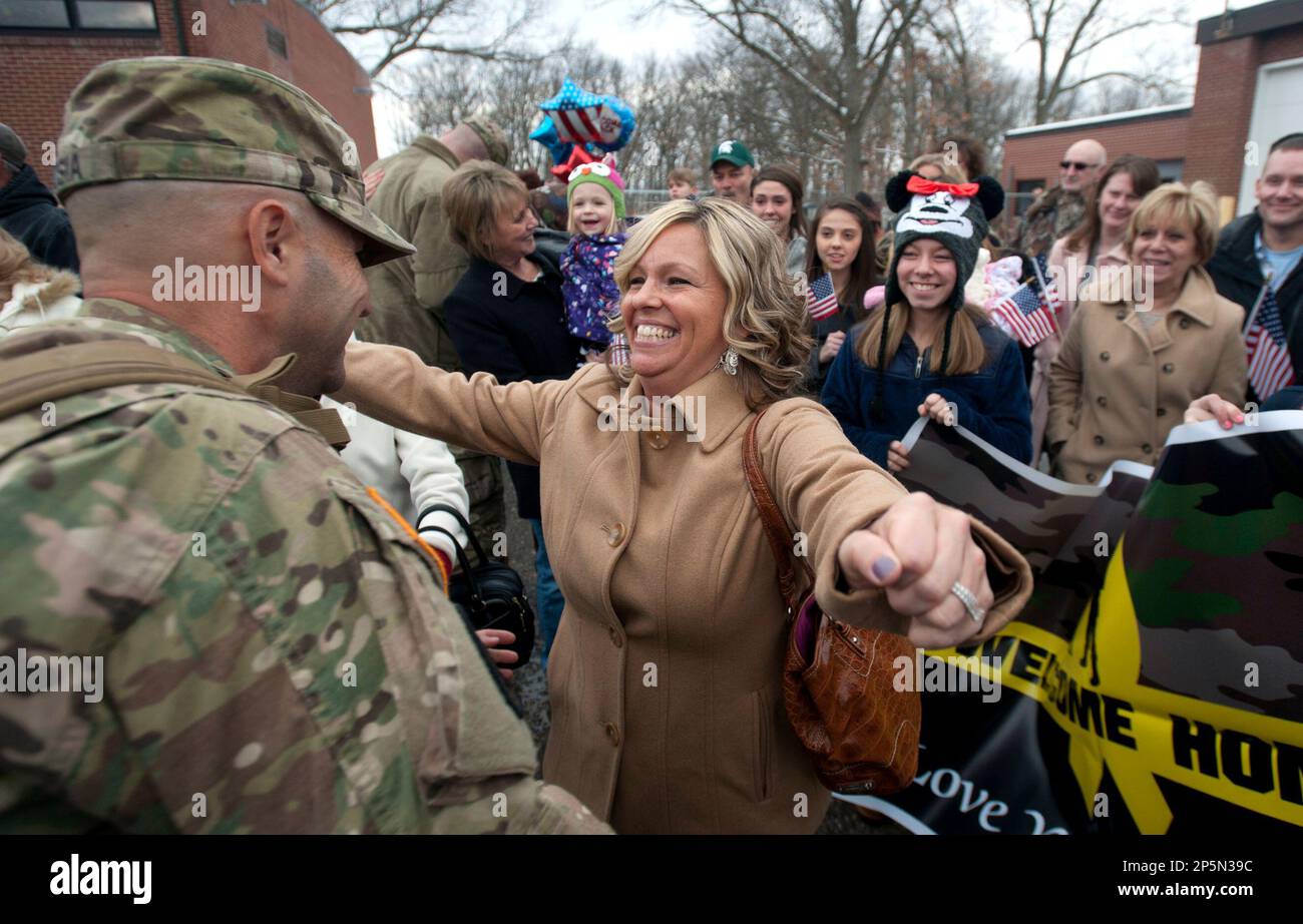 Amy DeRosia greets her husband, Sgt. Chad DeRosia, as members of the ...