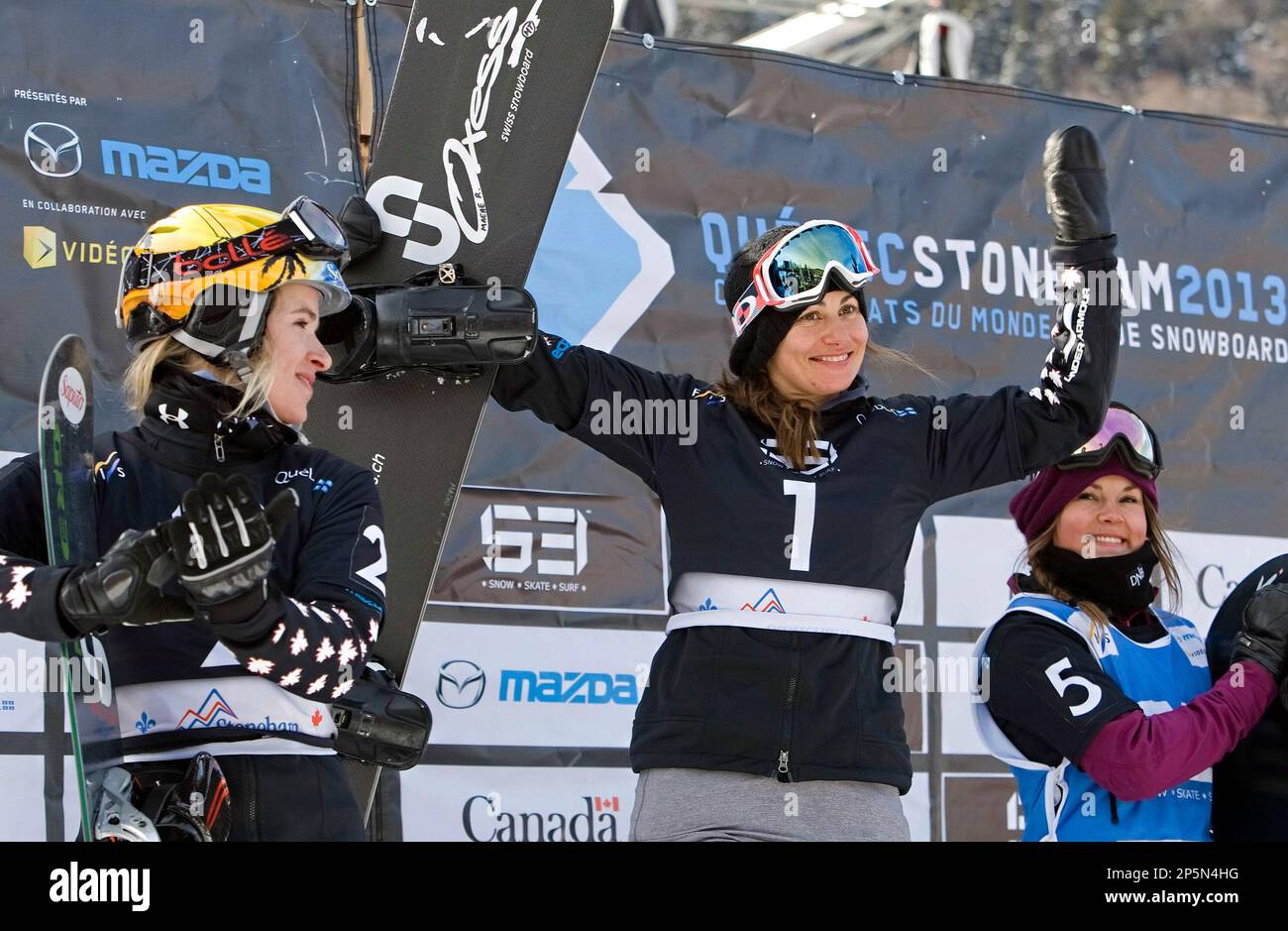 Gold medallist Maelle Ricker, center, of Canada, celebrates on the ...
