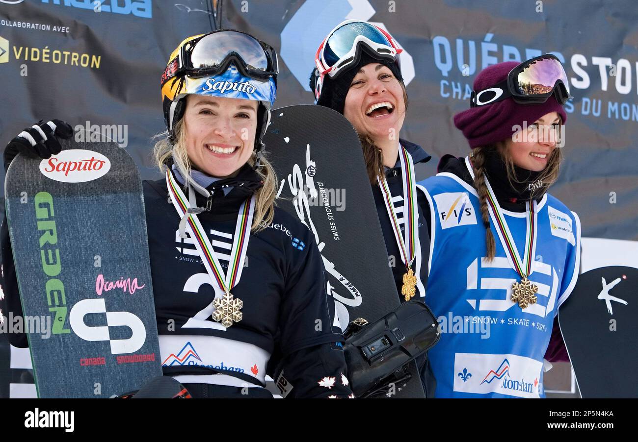 Gold medallist Maelle Ricker, center, of Canada, celebrates on the ...