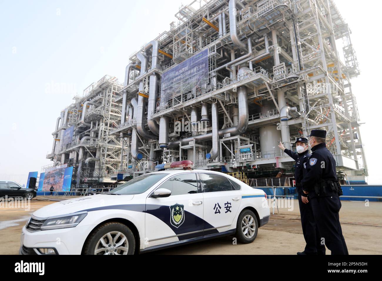 QINGDAO, CHINA - MARCH 7, 2023 - Police guard the loading of liquefied ...