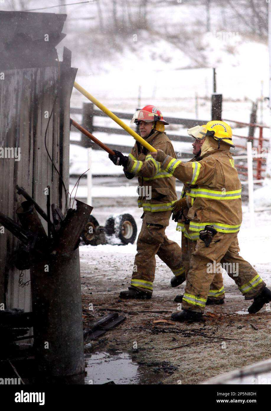Members of the Bonduel Area Fire Department pull down a wall from a ...