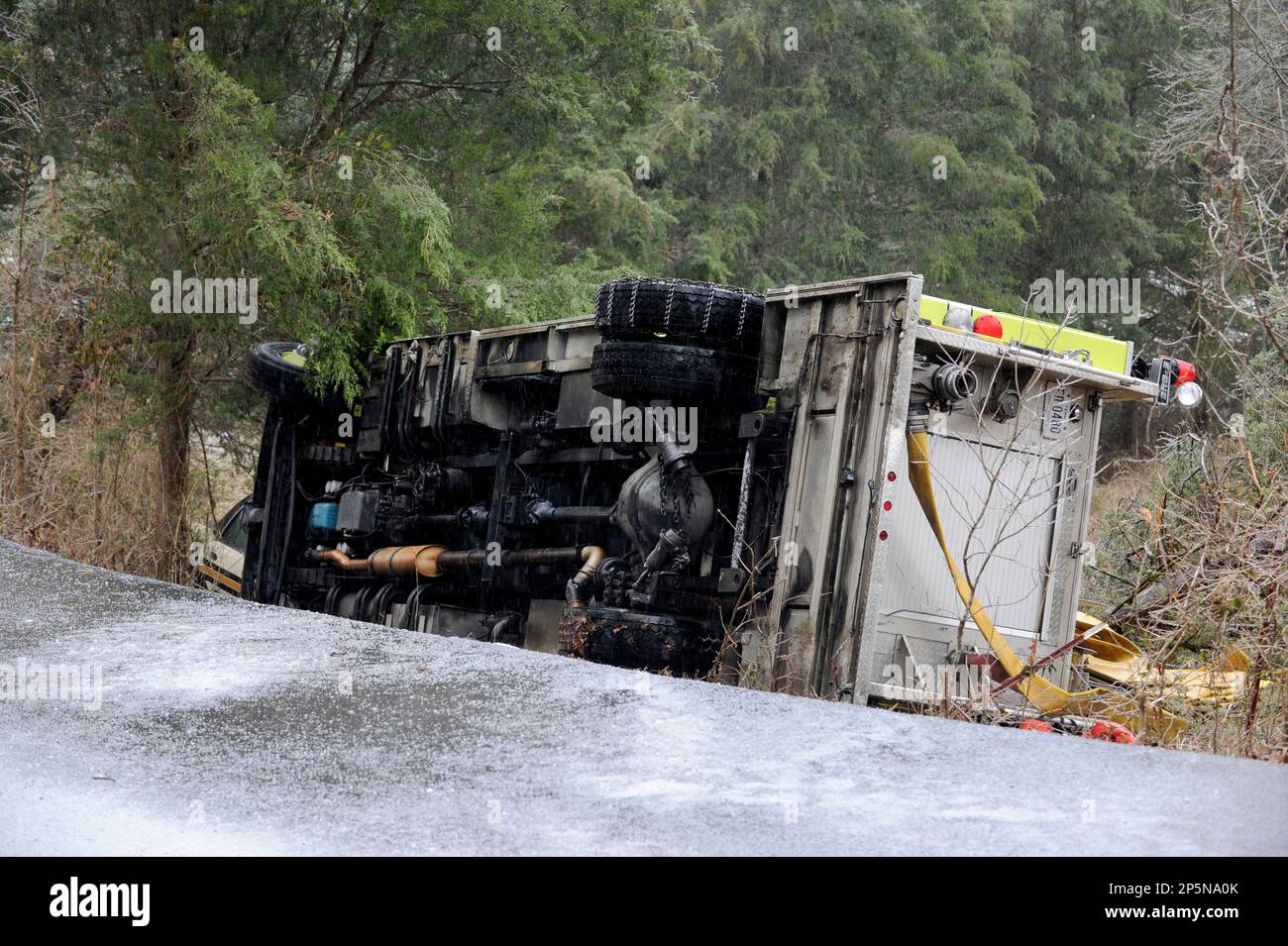 An overturned fire engine rests alongside Tennessee Highway Patrol ...