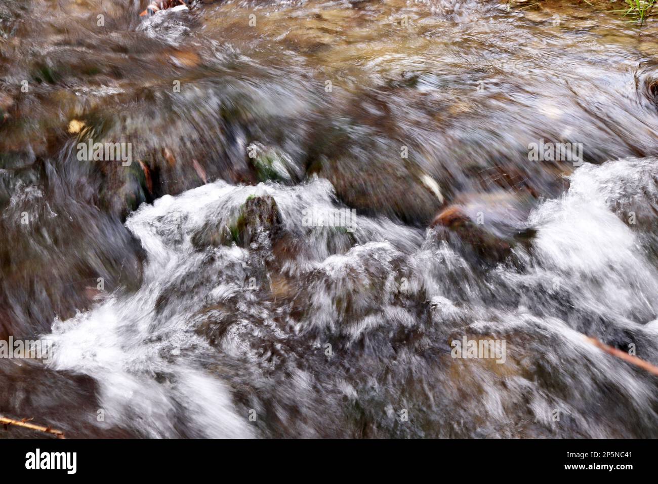 close-up view of a beautiful stream of water flowing down a narrow path ...