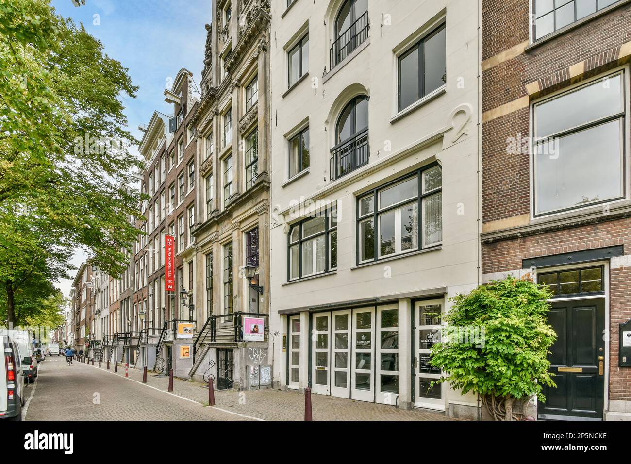 Amsterdam, Netherlands - 10 April, 2021: a city street with cars parked ...