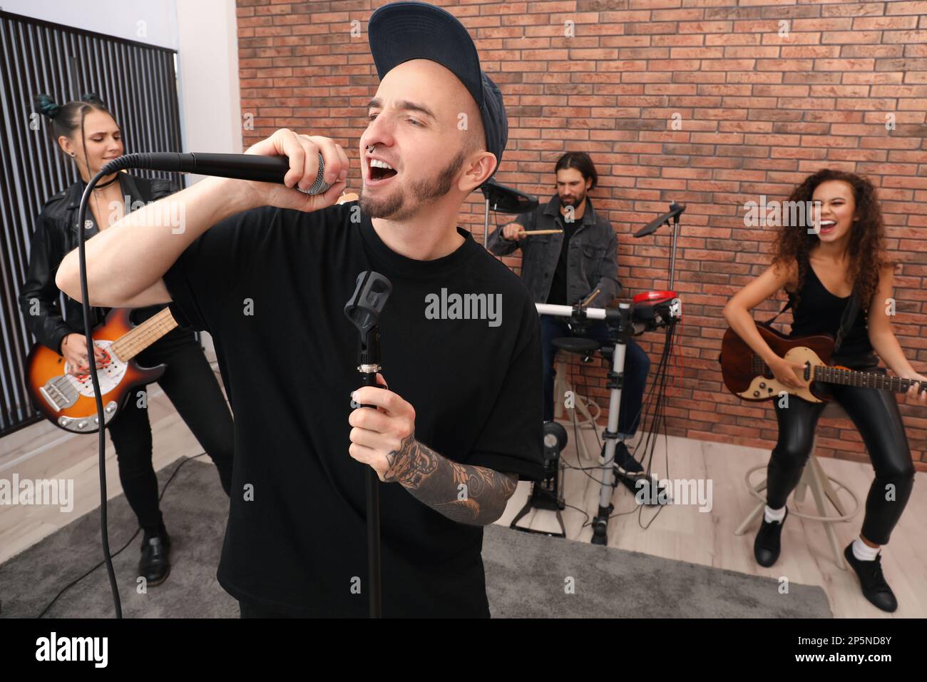 Music band performing in modern recording studio Stock Photo - Alamy