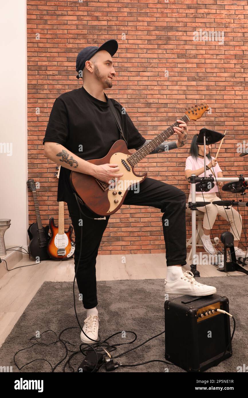 Music band performing in modern recording studio Stock Photo - Alamy