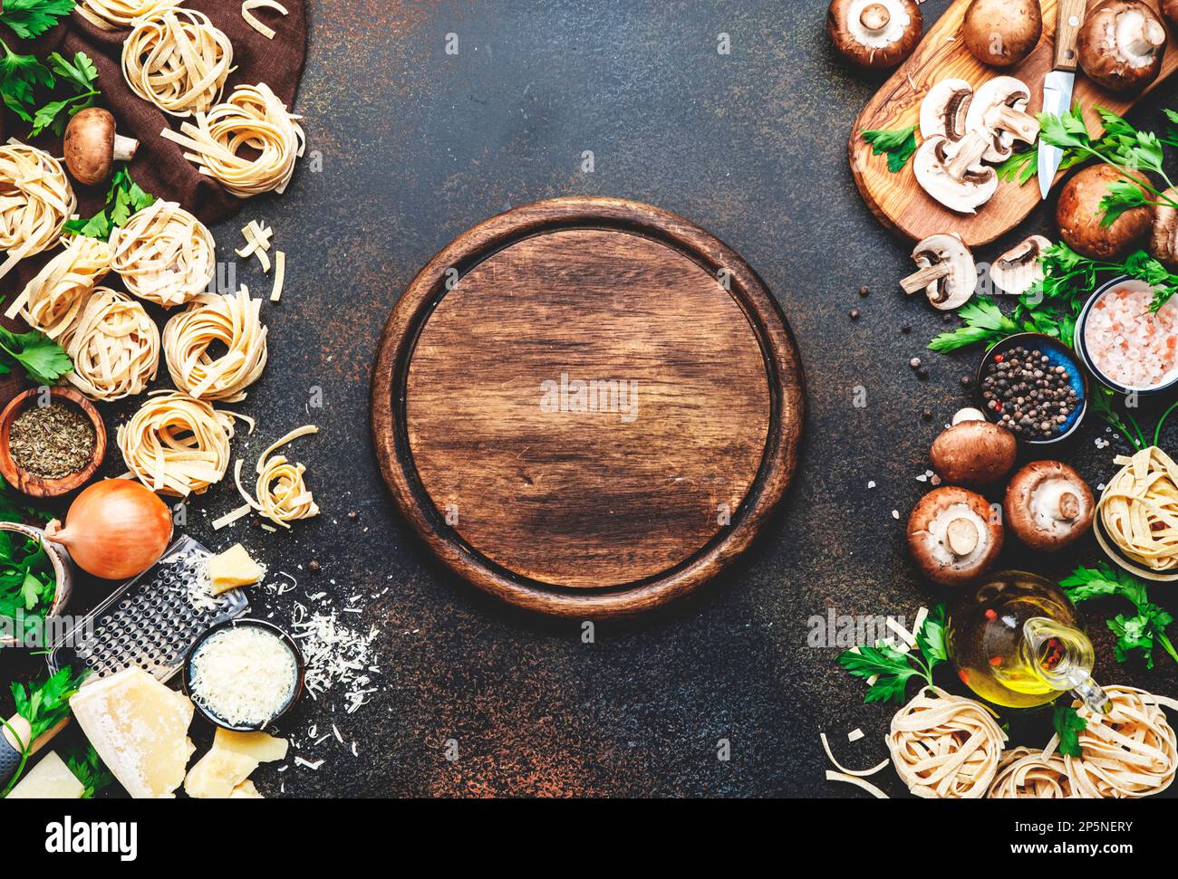 Food background. Uncooked pasta, brown mushrooms, vegetables, cheese ...