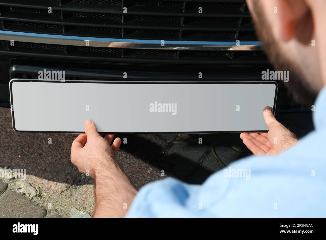 Man installing vehicle registration plate outdoors, closeup Stock Photo ...