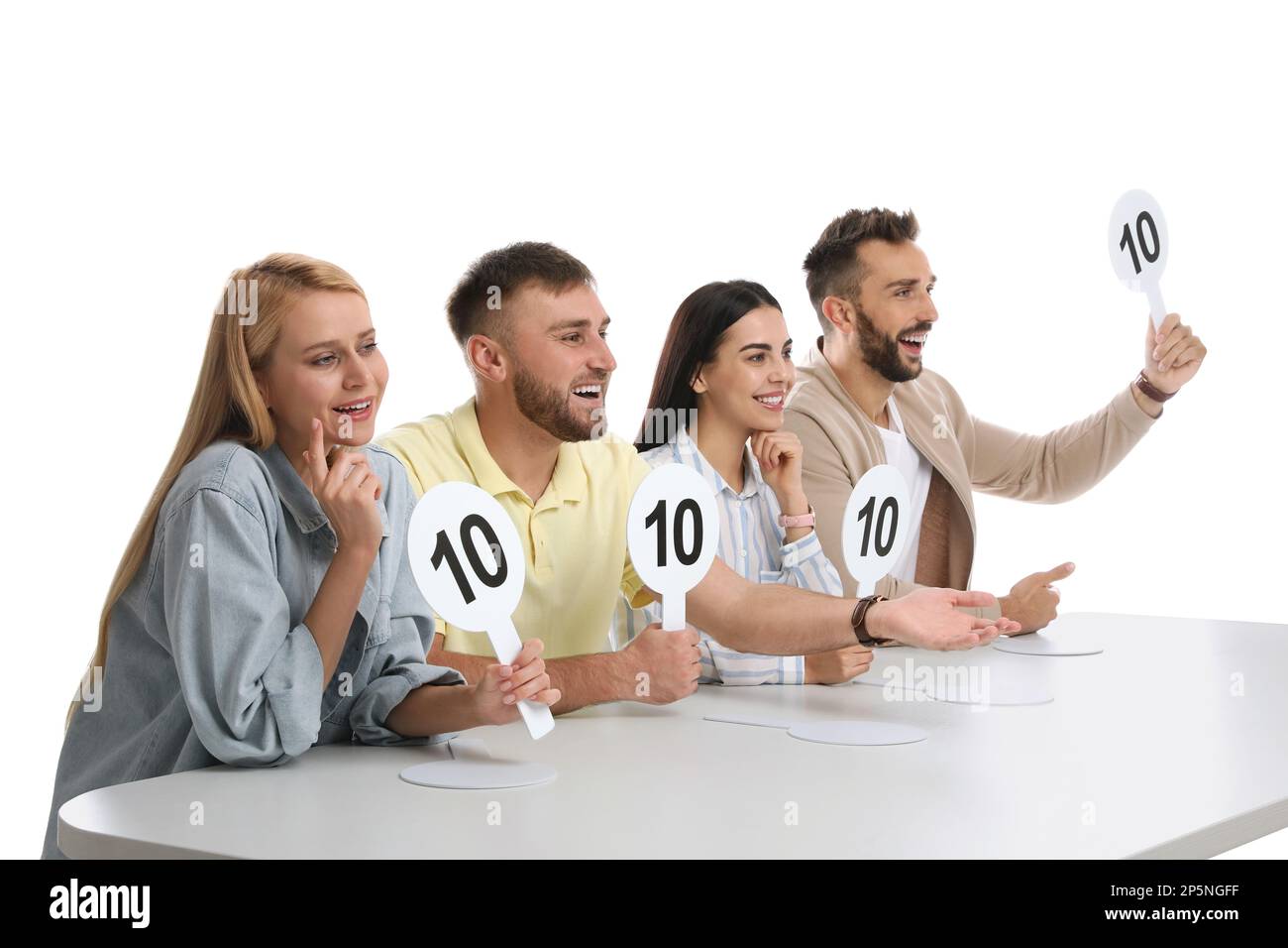 Panel of judges holding signs with highest score at table on white ...