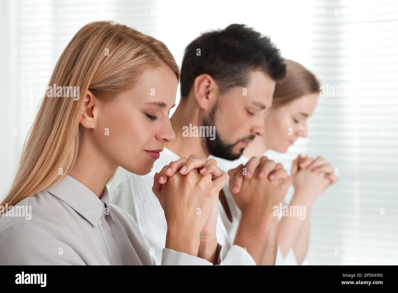 Group people praying together hi-res stock photography and images - Alamy