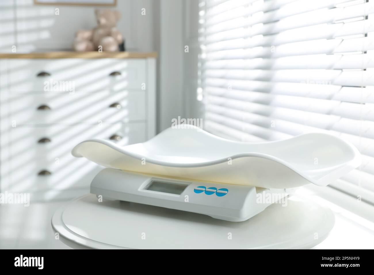 Modern digital baby scales on table in room Stock Photo - Alamy