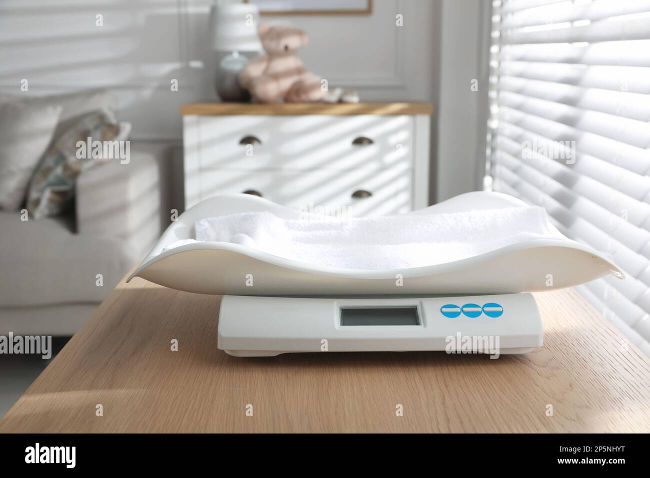 Modern digital baby scales on wooden table in room Stock Photo - Alamy