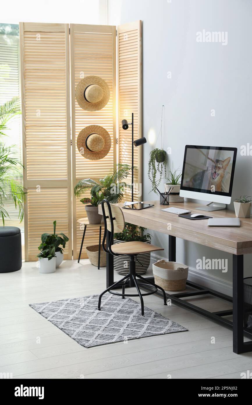 Comfortable workplace with computer in light room. Interior design ...