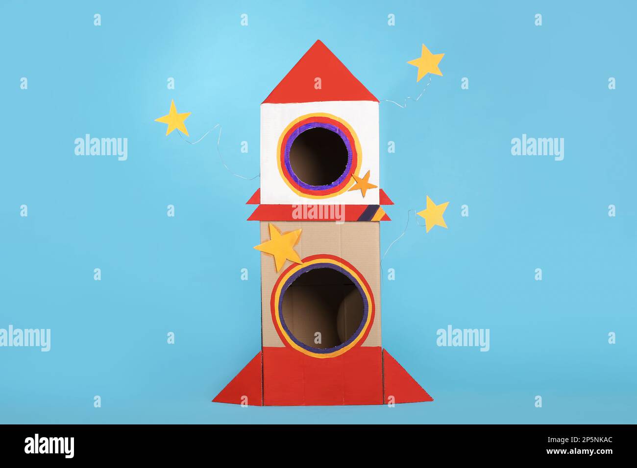 Cute handmade cardboard spaceship on light blue background Stock Photo ...