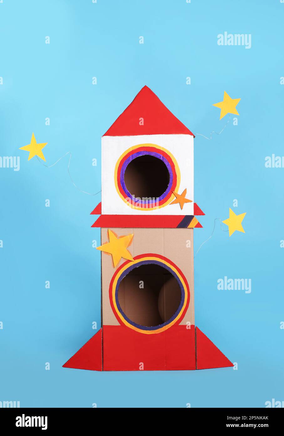 Cute handmade cardboard spaceship on light blue background Stock Photo ...