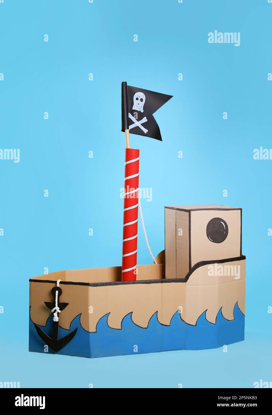 Pirate cardboard ship with flag on turquoise background Stock Photo - Alamy