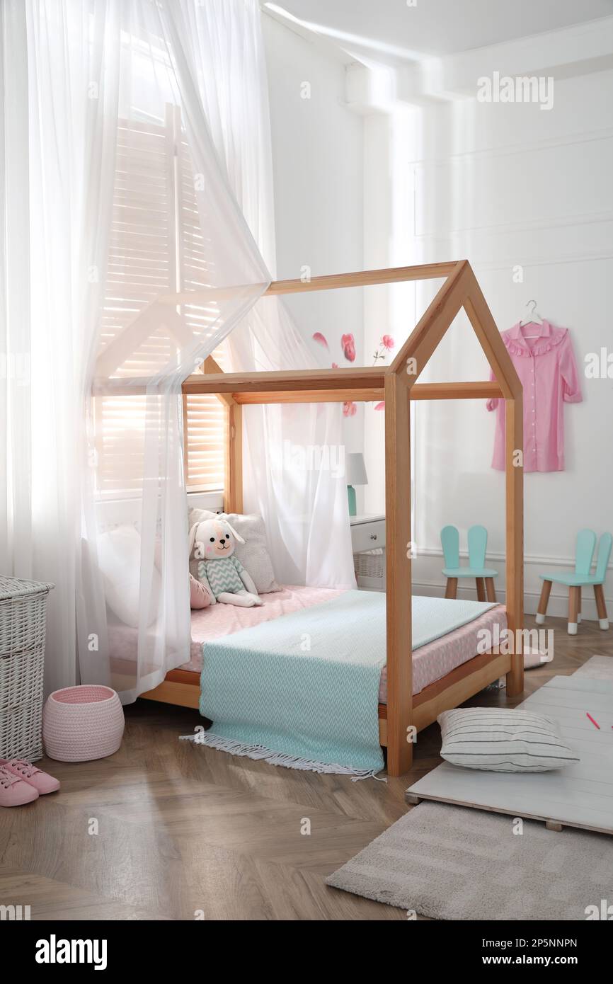 Stylish child room interior with wooden house bed Stock Photo - Alamy