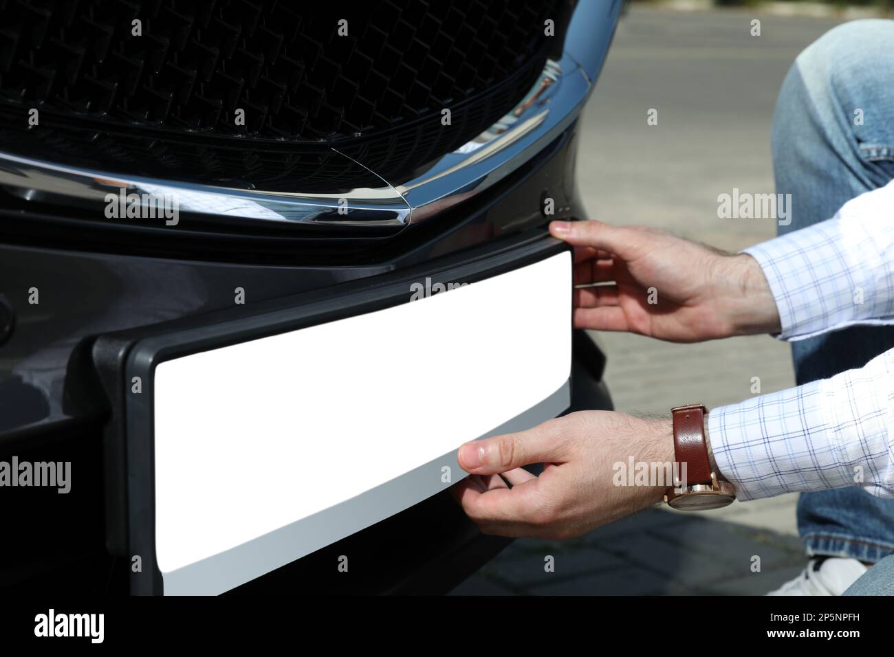 Man installing vehicle registration plate outdoors, closeup Stock Photo ...