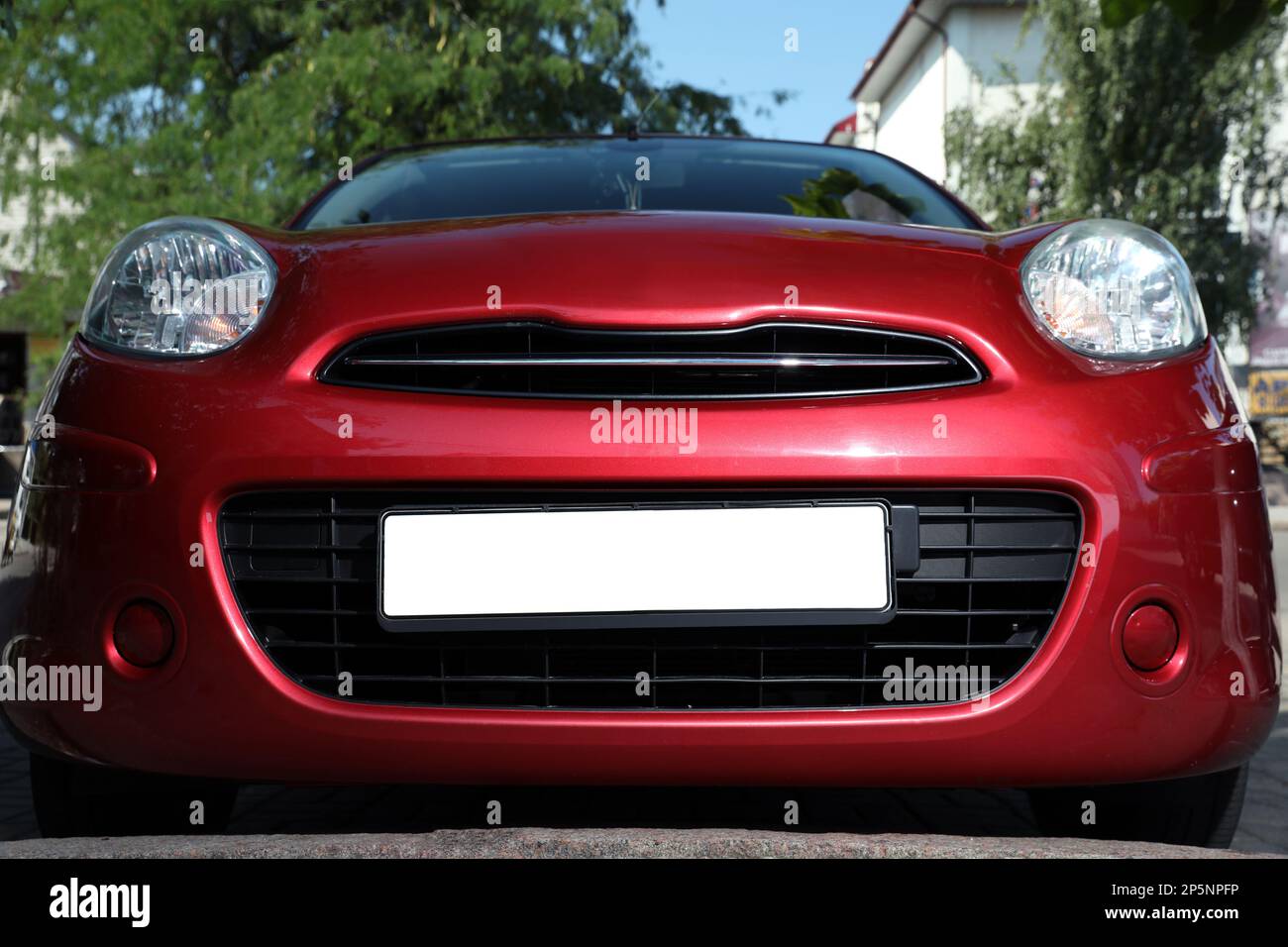 Red car with vehicle registration plate outdoors Stock Photo - Alamy