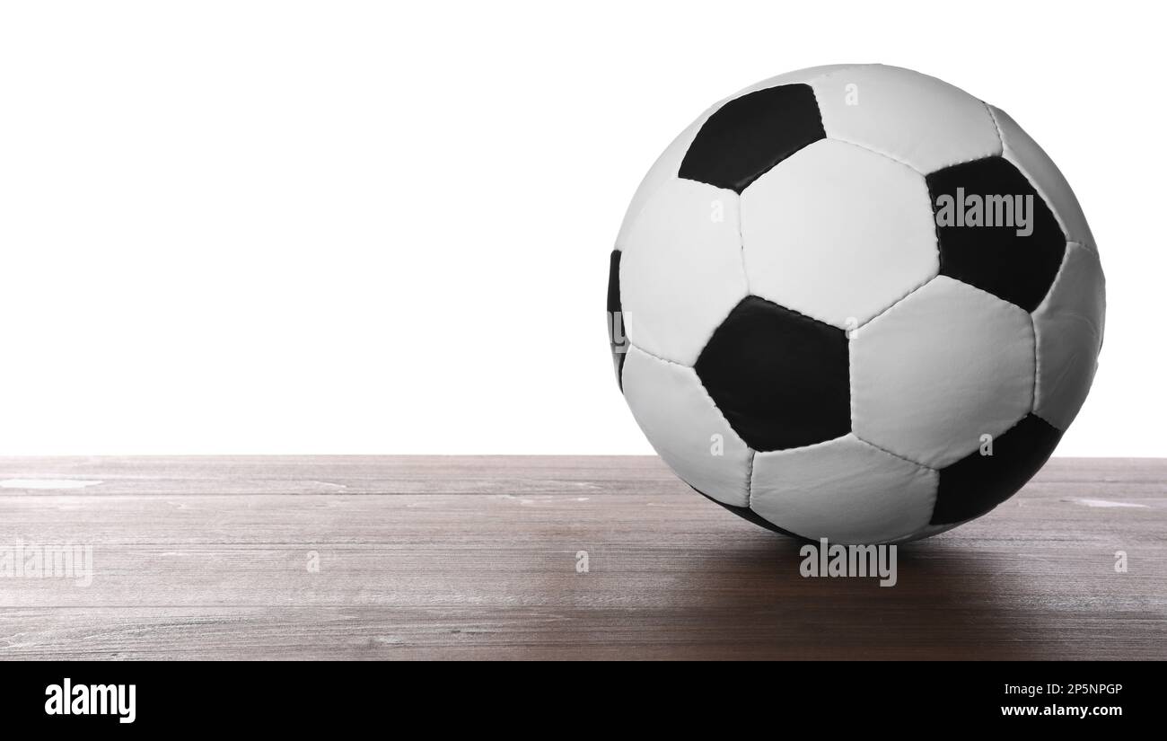 Football ball on wooden table against white background. Space for text ...
