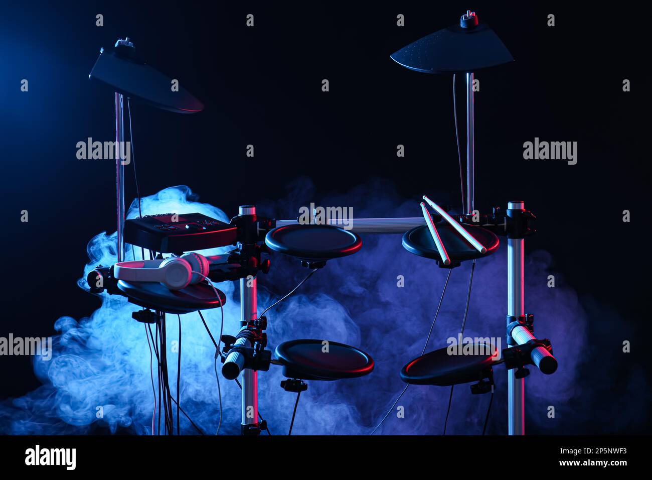 Modern electronic drum kit and smoke on dark background, color toned ...