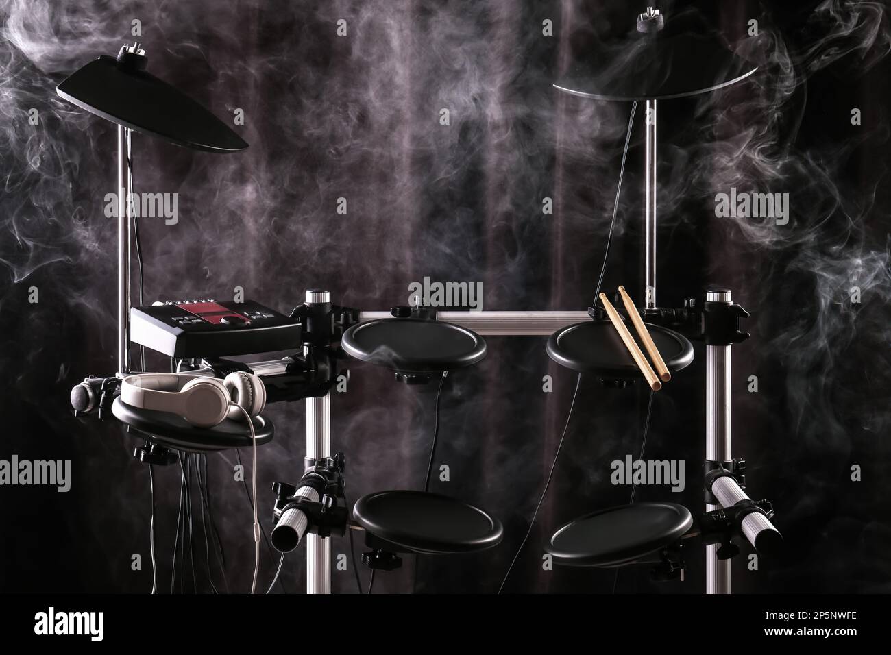 Modern electronic drum kit and smoke on dark background. Musical ...